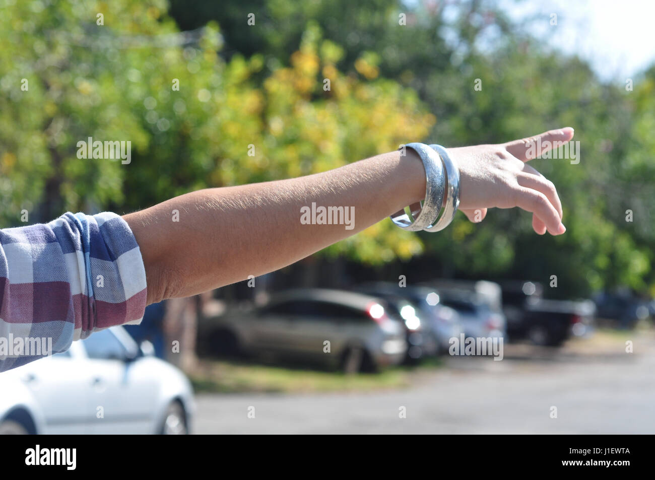 Woman hand pointing outdoors Stock Photo - Alamy