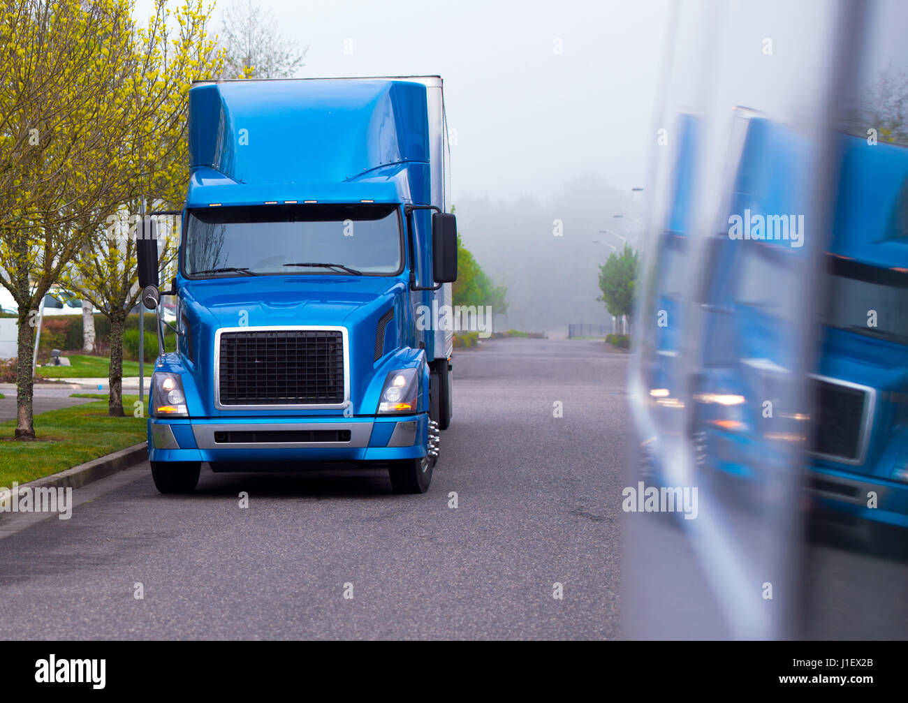 Professional blue semi truck with a spoiler on the roof and strict ...