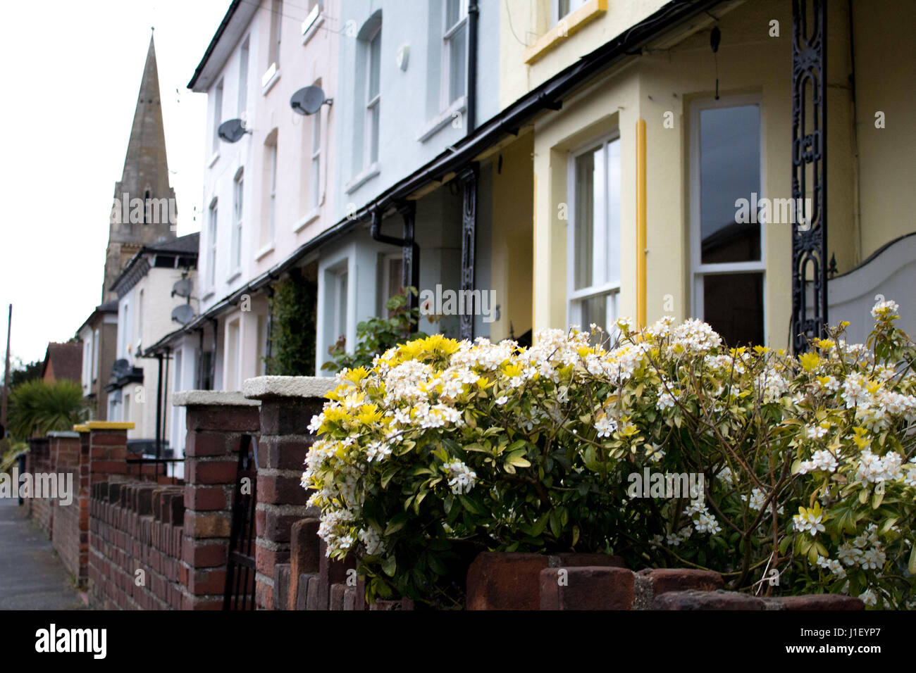 View down colourful terrace ending in a church spire in the small ...