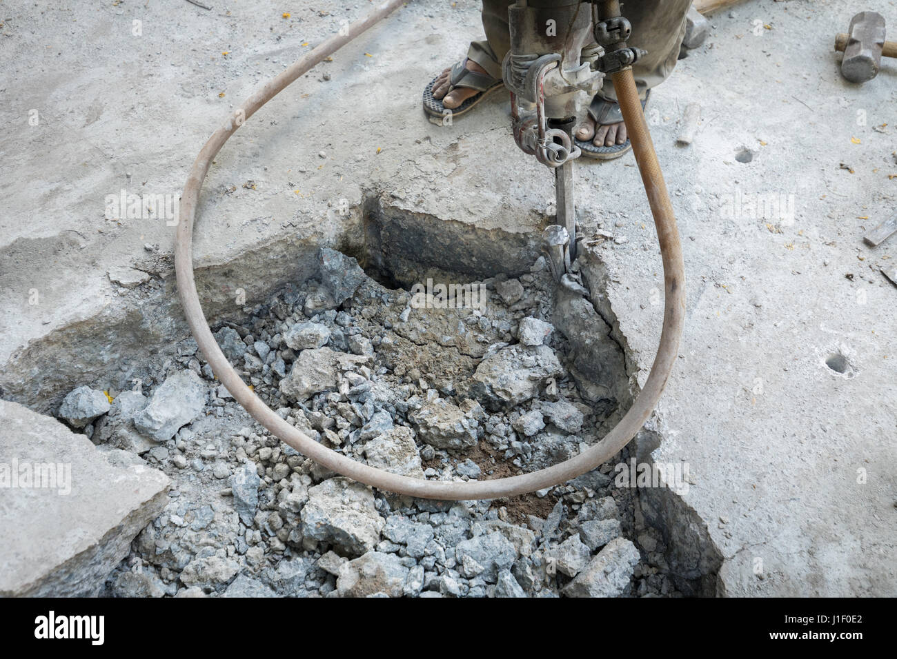 Worker using pneumatic hammer on city pavement Stock Photo - Alamy