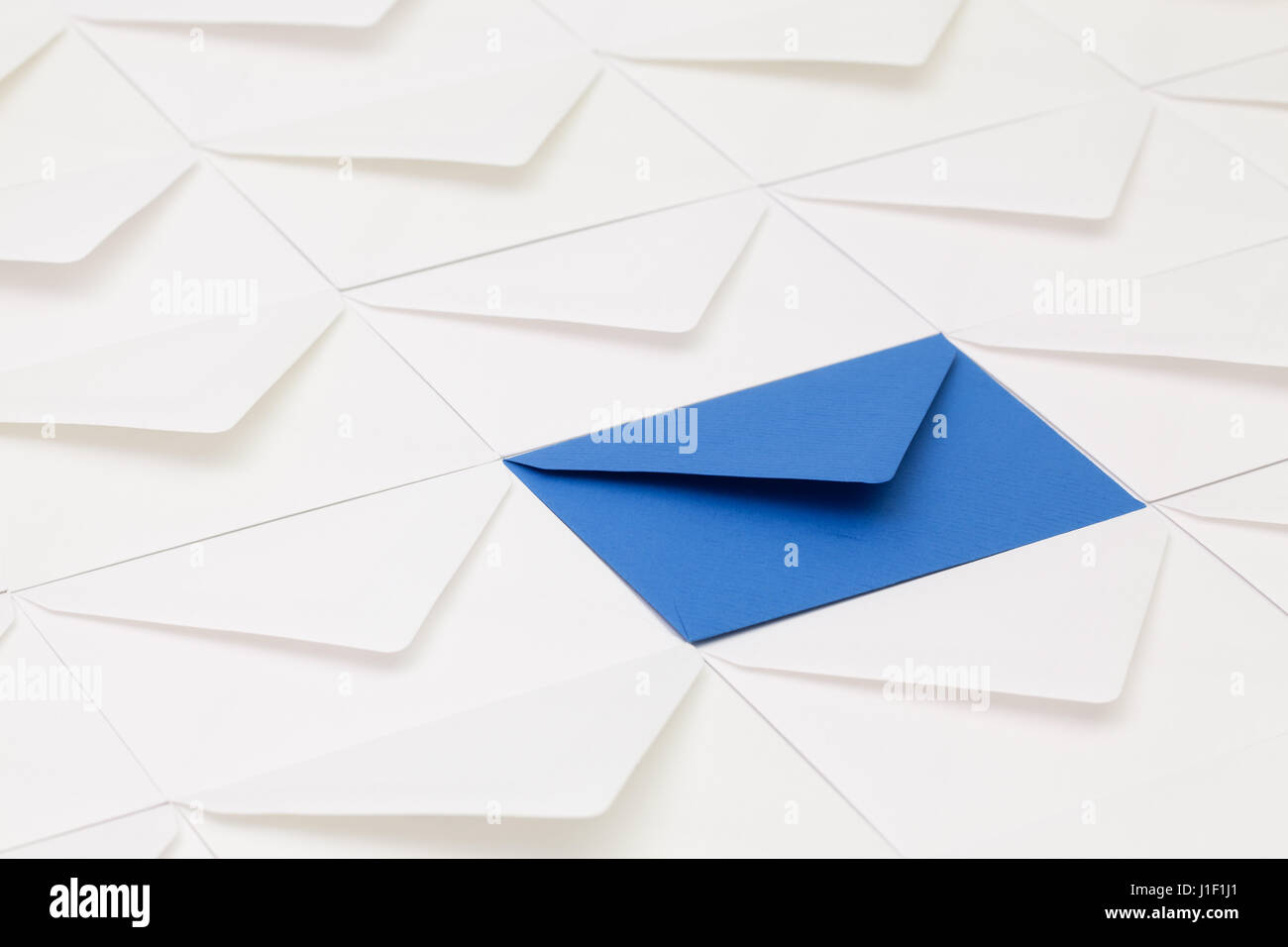 Composition with white envelopes and one dark blue envelope on the ...