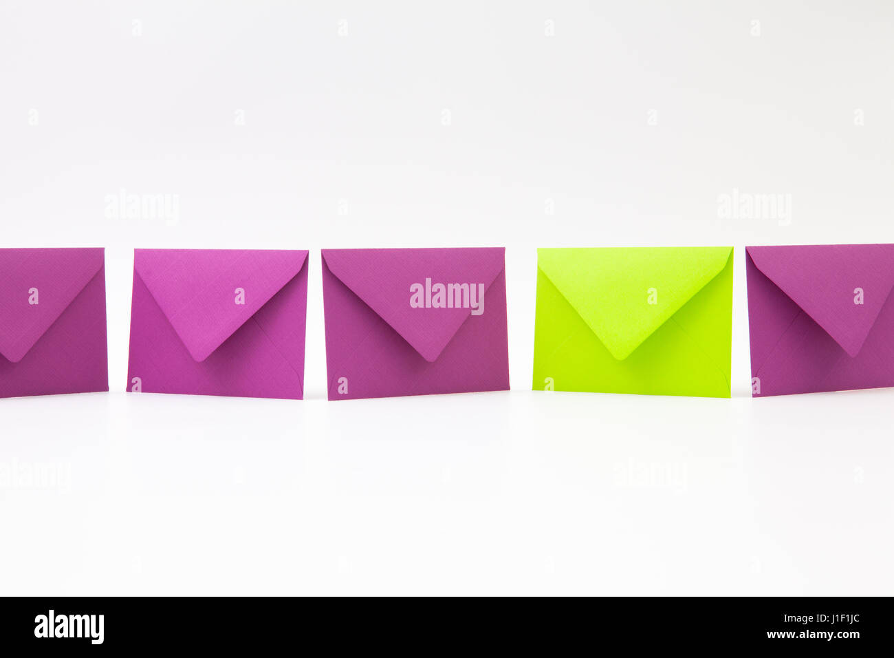 Different colored envelopes on the table Stock Photo - Alamy