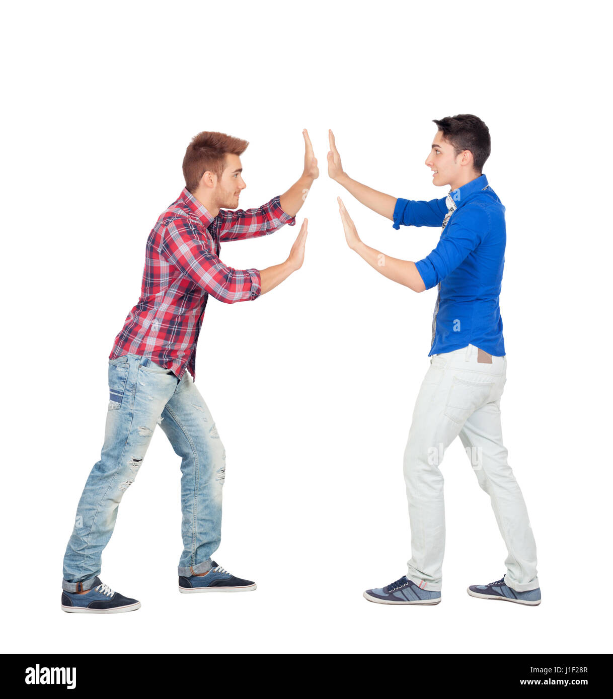 Two guys pushing against isolated on a white background Stock Photo - Alamy
