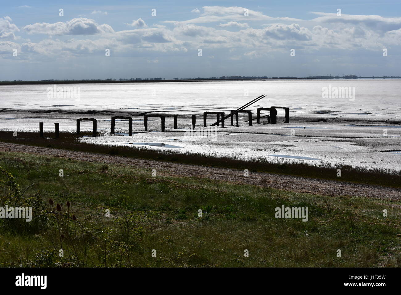 Silhouette of Old Jetty at Snettisham Beach nature reserve on the wash ...