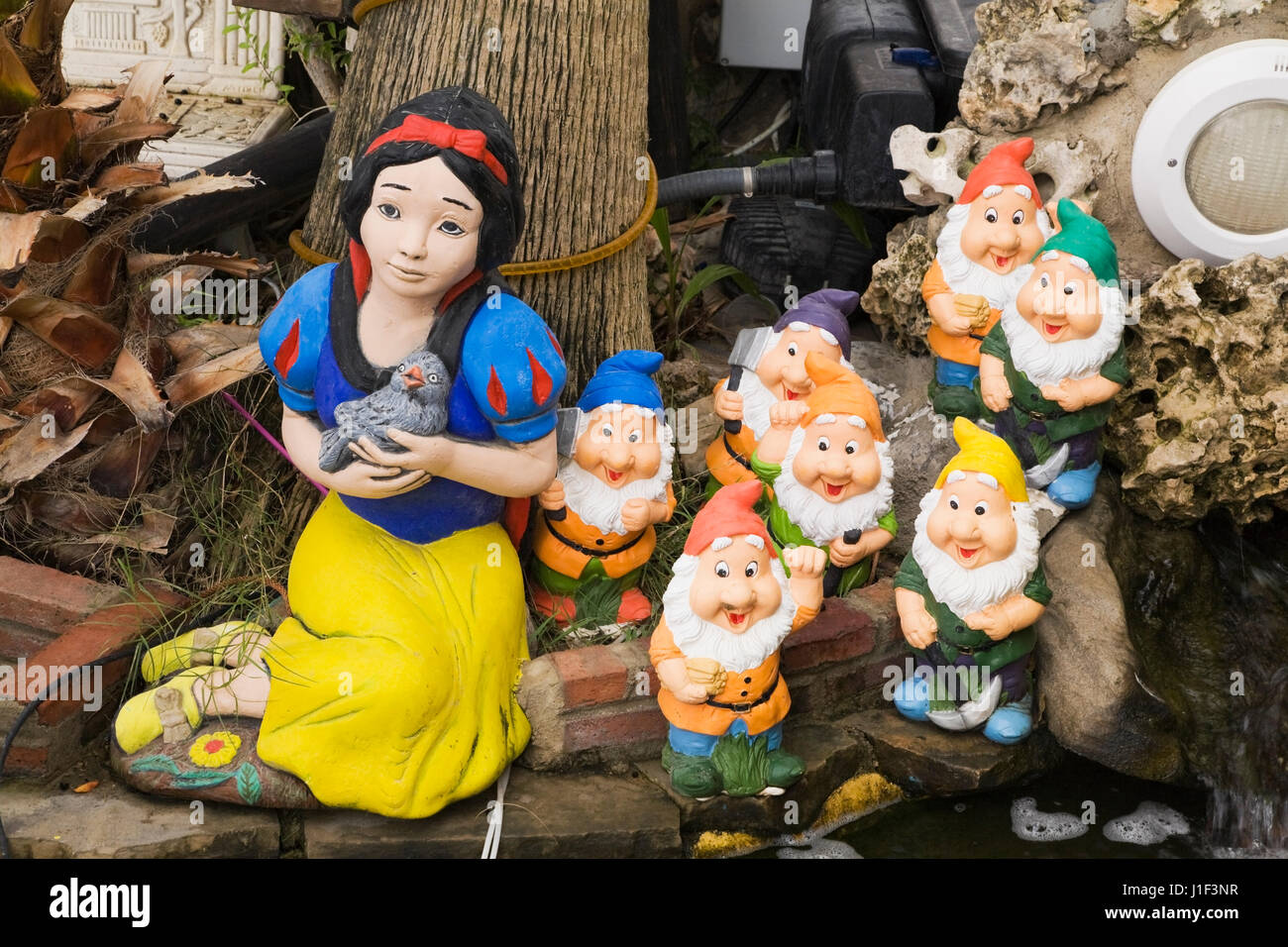 Snow-white and the seven drawfs statuettes in a landscaped garden Stock ...