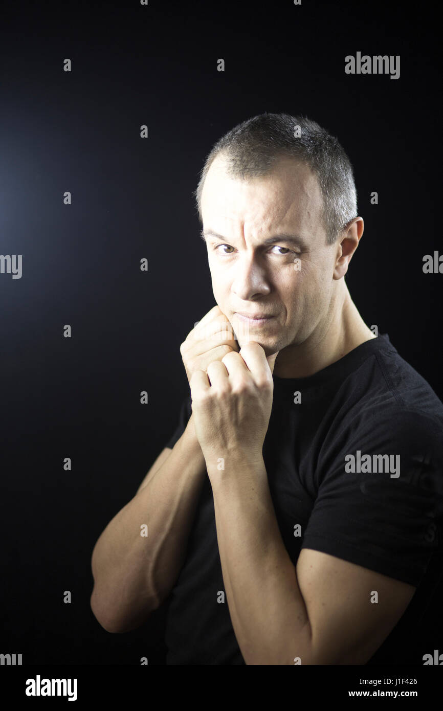 Attractive handsome slim healthy man aged in 40's in black t-shirt ...