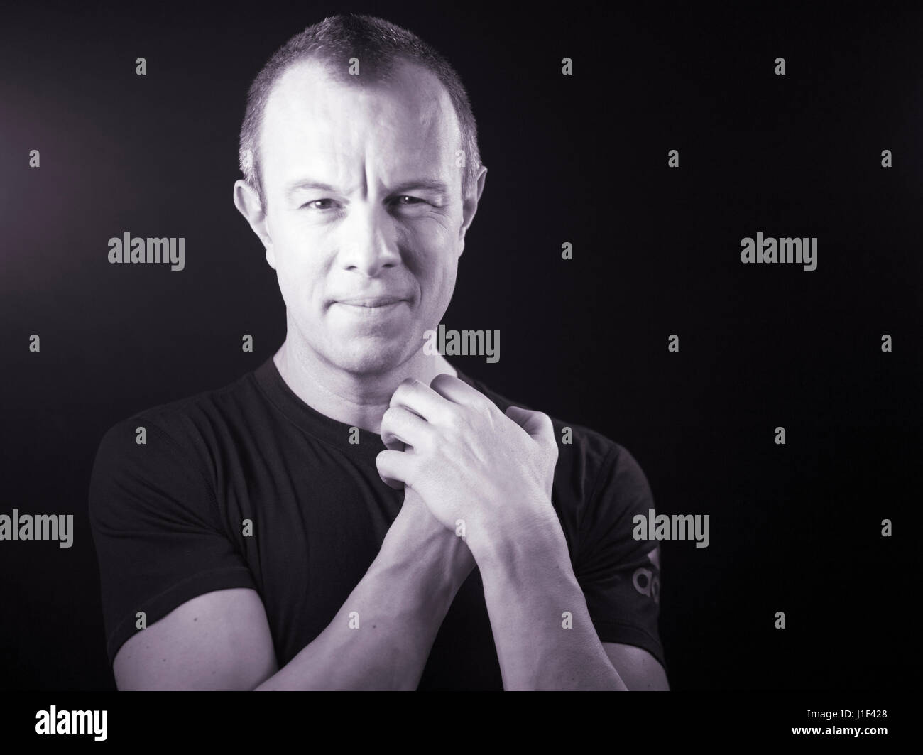 Attractive handsome slim healthy man aged in 40's in black t-shirt ...