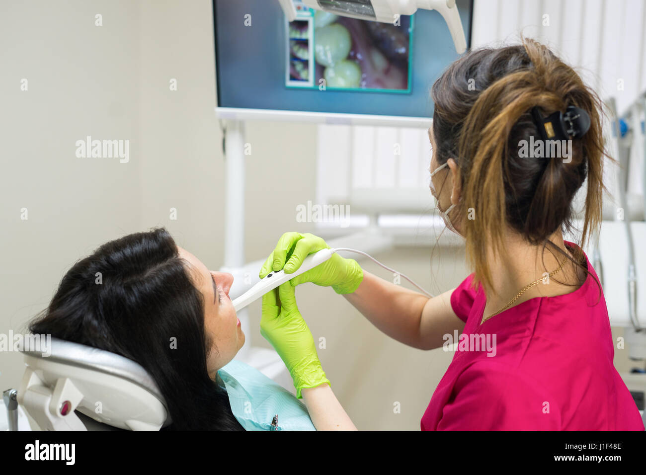 Dentist examining woman's teeth with camera Stock Photo - Alamy