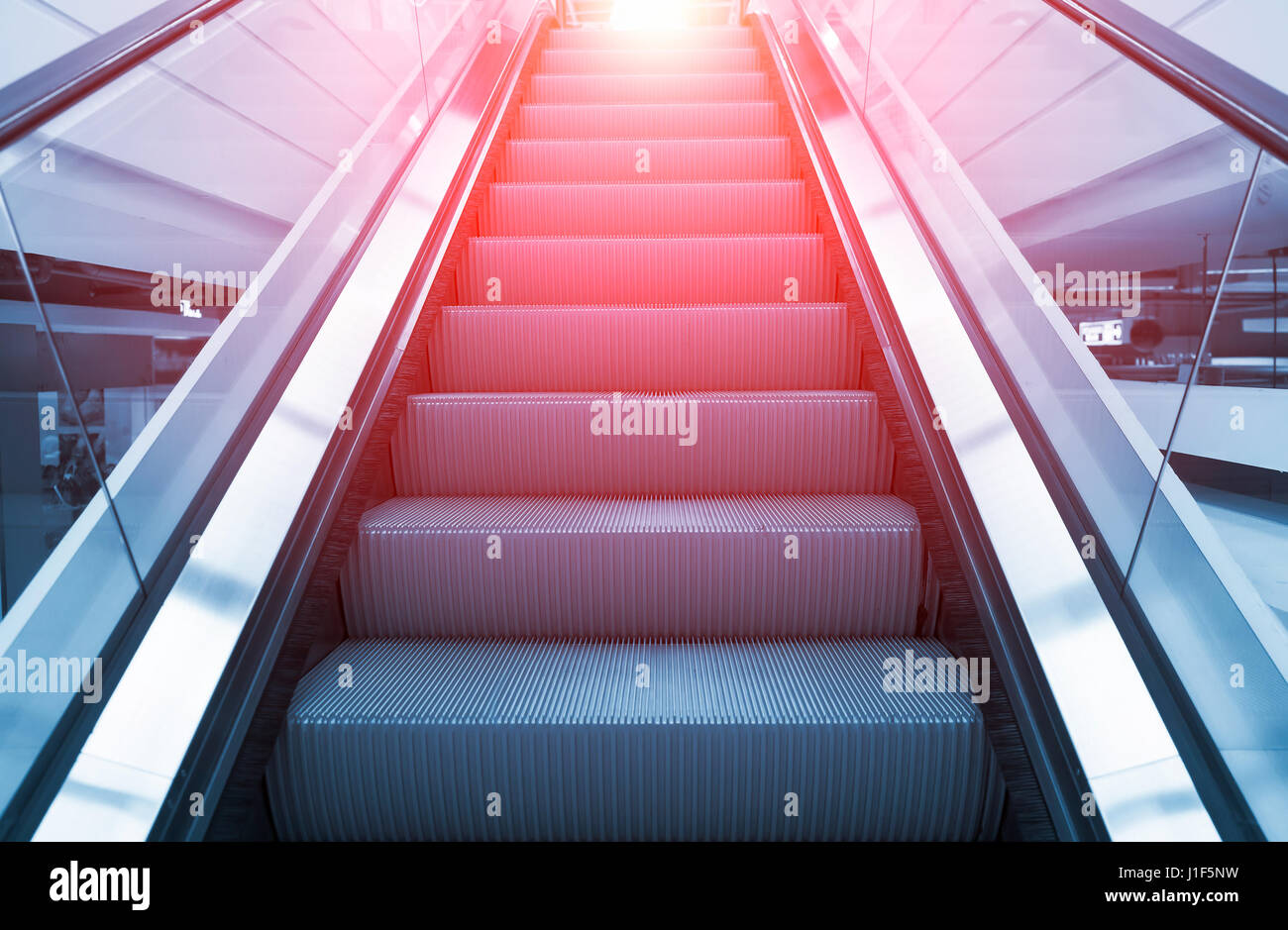 Escalator and step inside building Stock Photo - Alamy