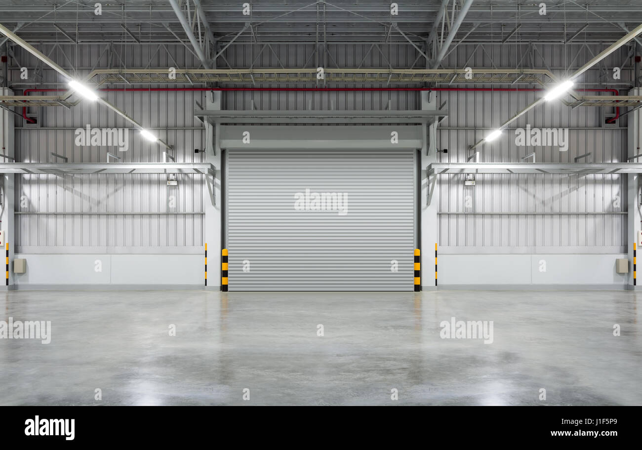 Shutter door or roller door and concrete floor inside factory building use for industrial ...