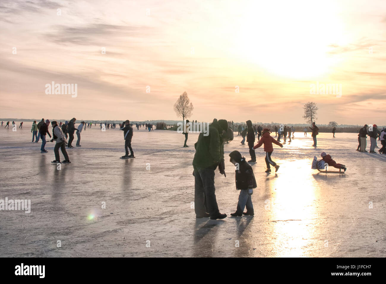Ice skating at sunset Stock Photo - Alamy