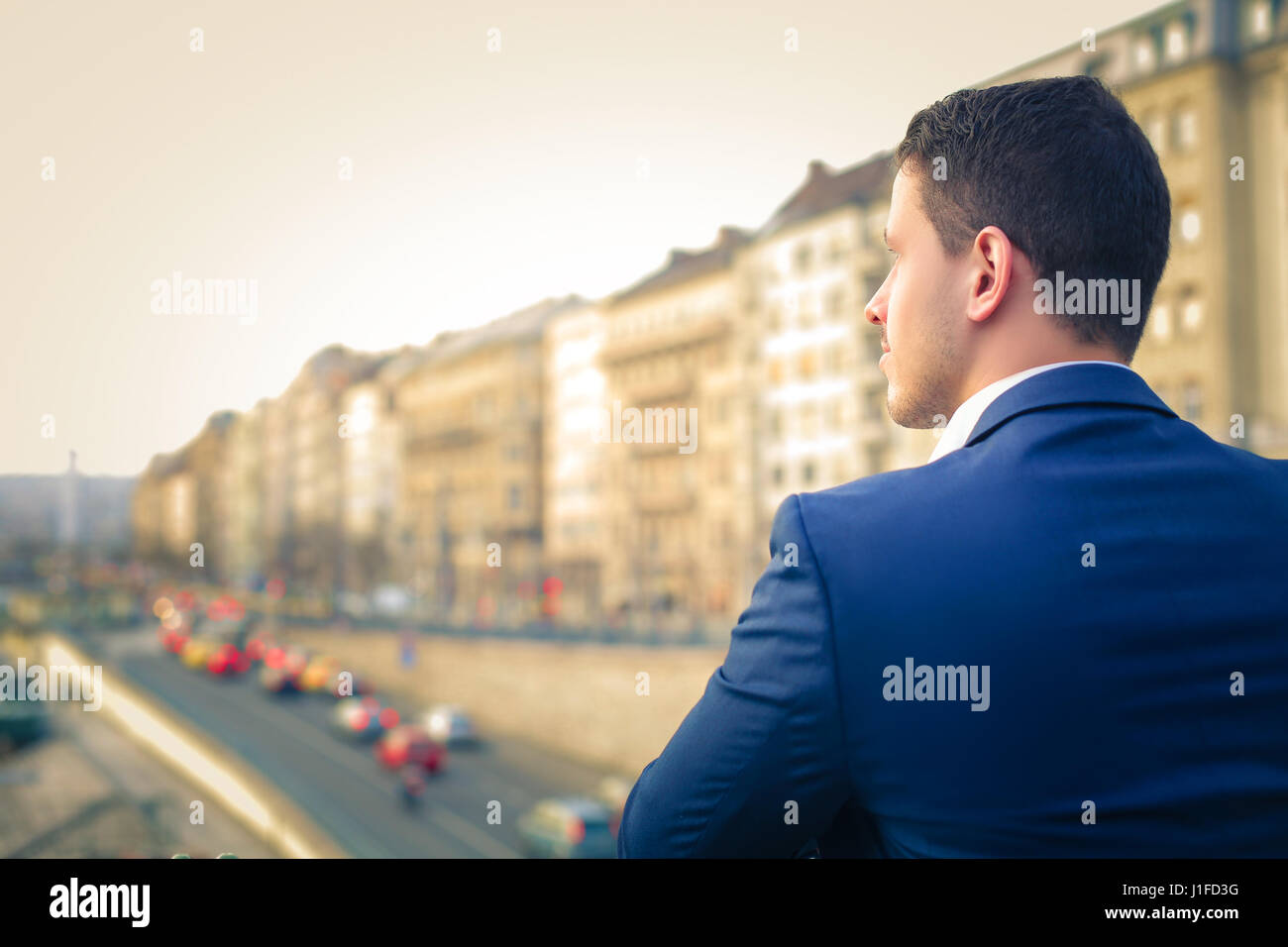 Young man looking a city view Stock Photo - Alamy