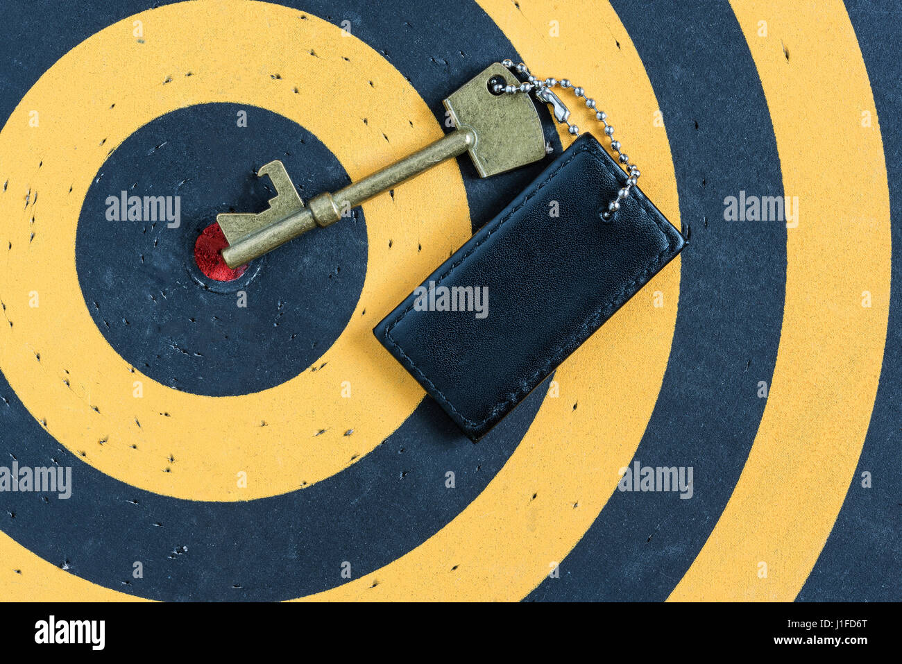 old key to success concept with blank tag over red target on dartboard ...