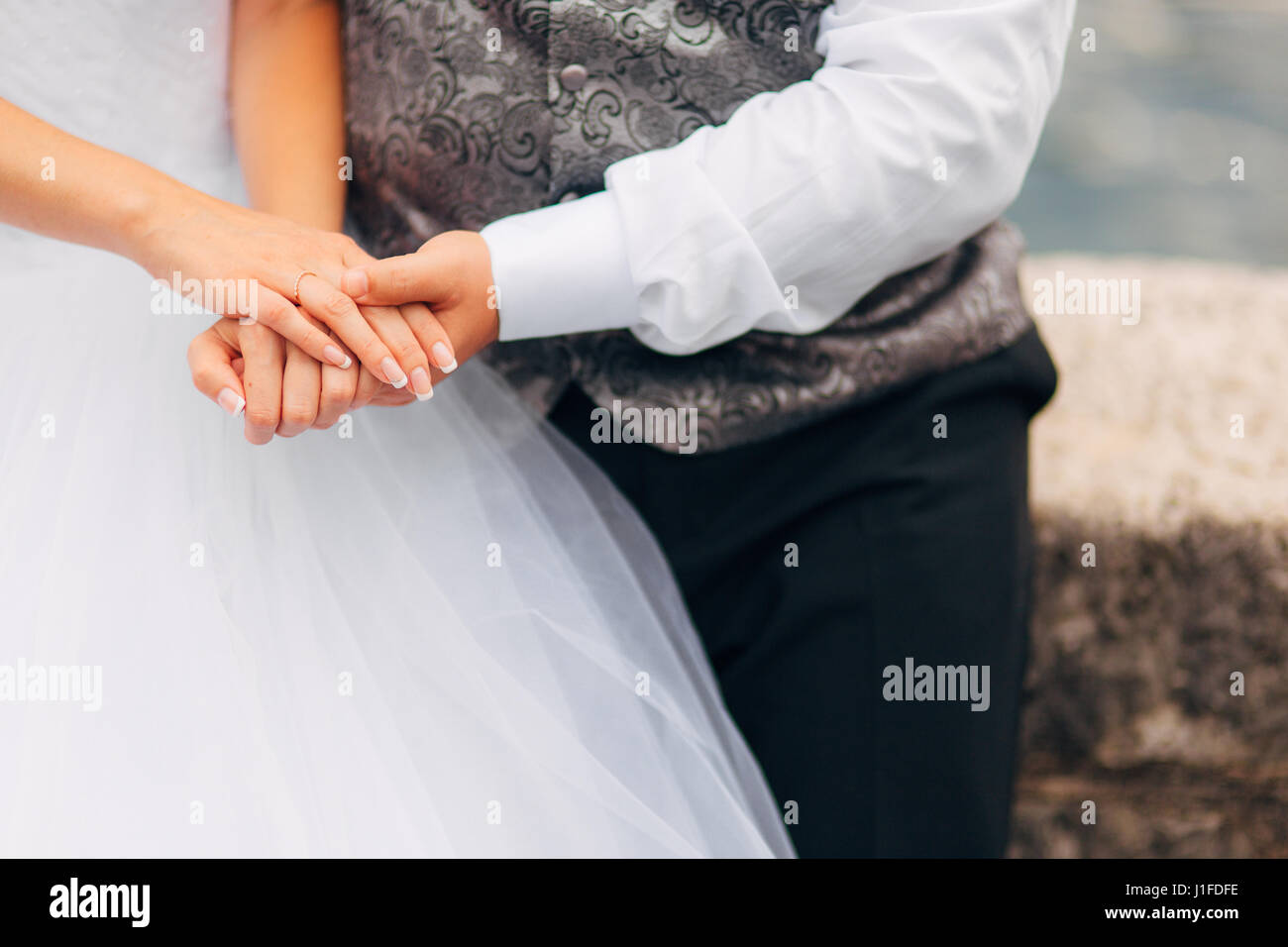 Bride and groom holding hands Stock Photo - Alamy