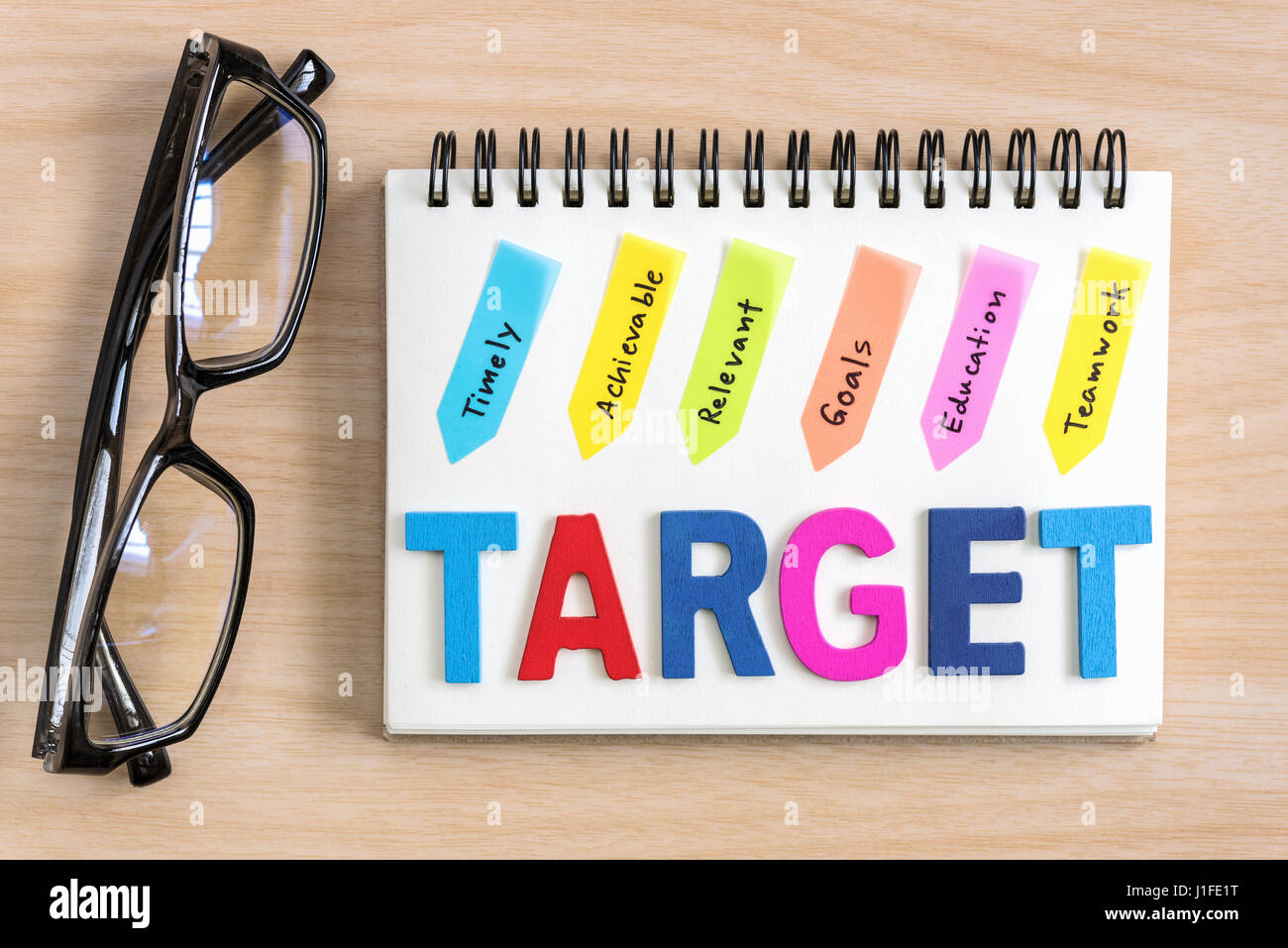 Wood letter of target word with hand writing definition in colorful ...