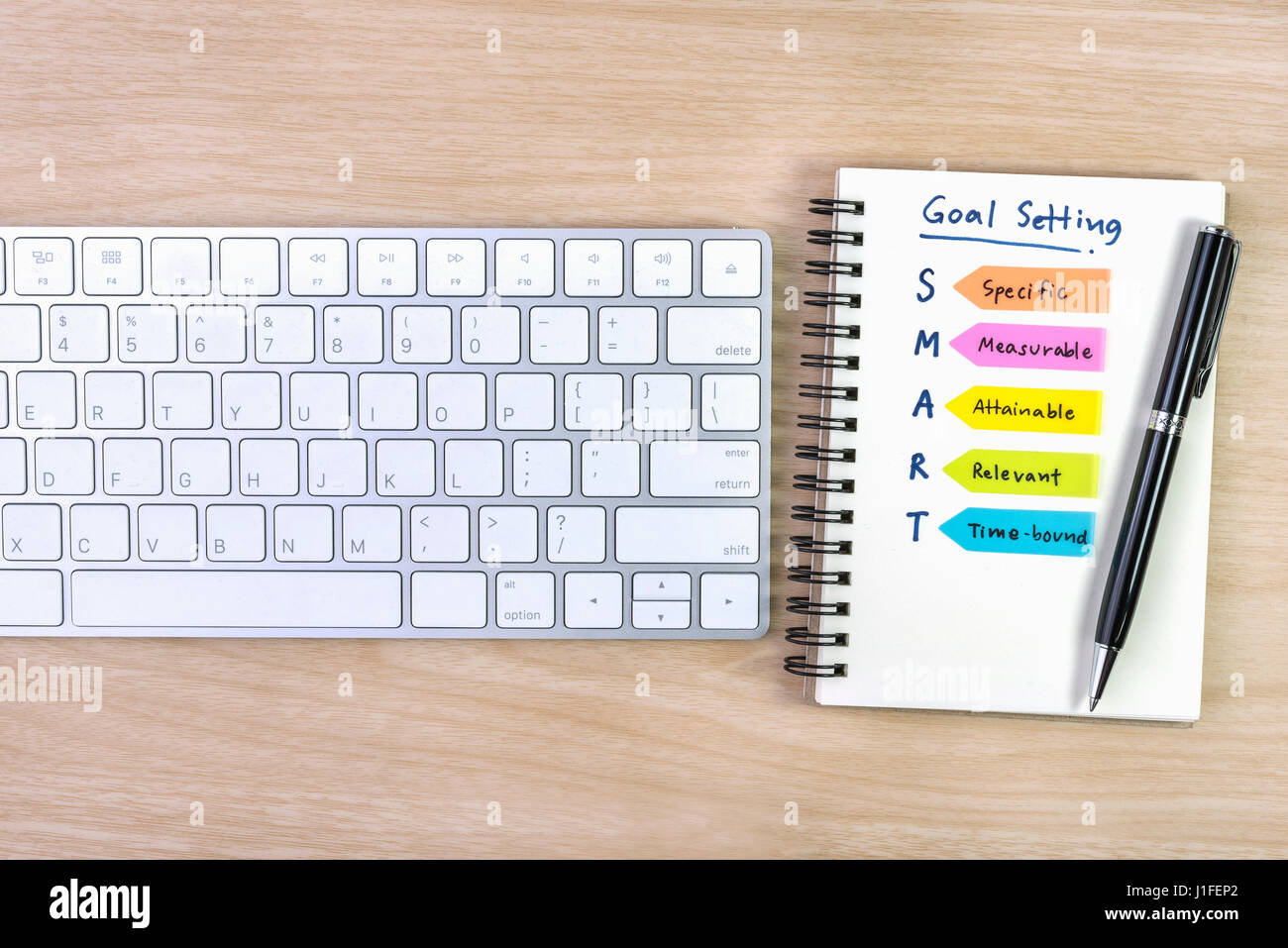 smart goals setting written on the notebook with pen and keyboard over ...
