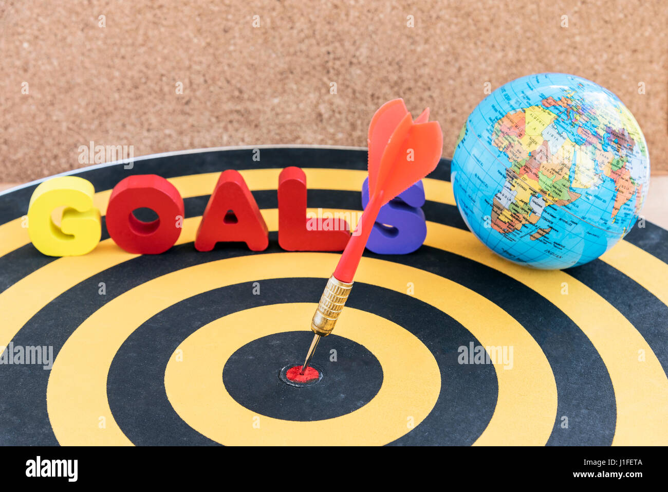 dart arrow hitting in target bullseye of center on dartboard with globe ...