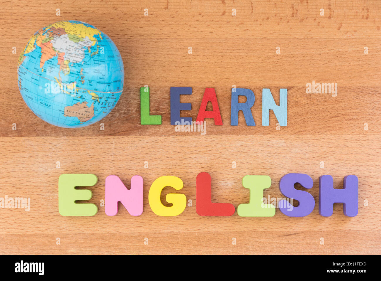 word learn english with globe over wooden background, education concept ...