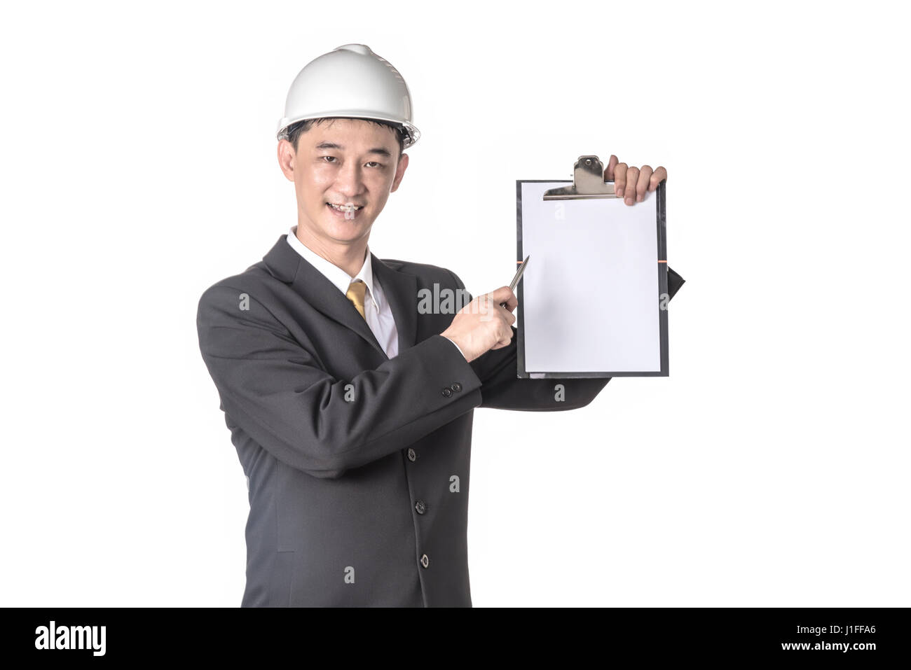 Smiling handsome foreman in helmet showing blank paper on clipboard ...