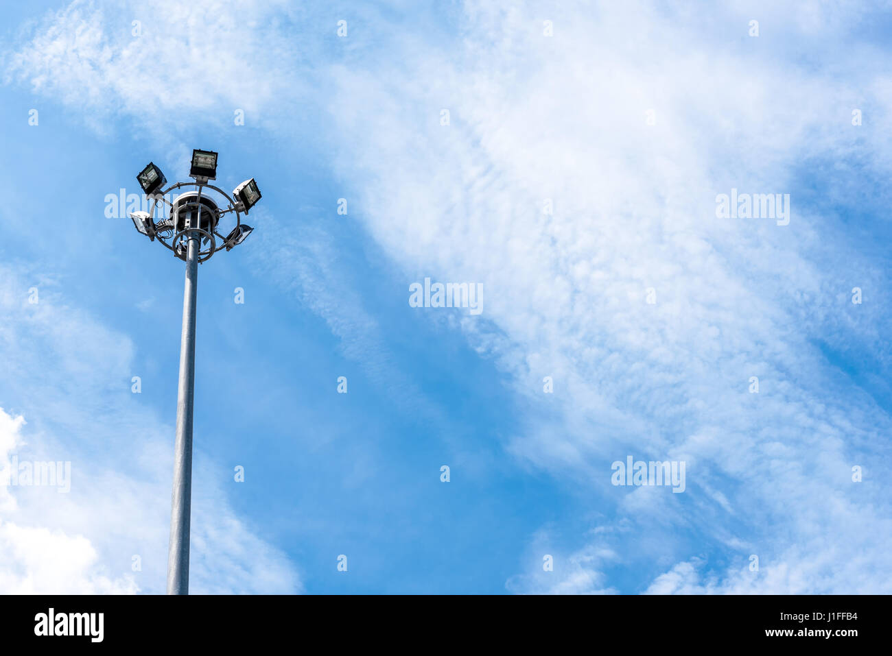 Electric light post with blue sky and clouds background with copy space ...