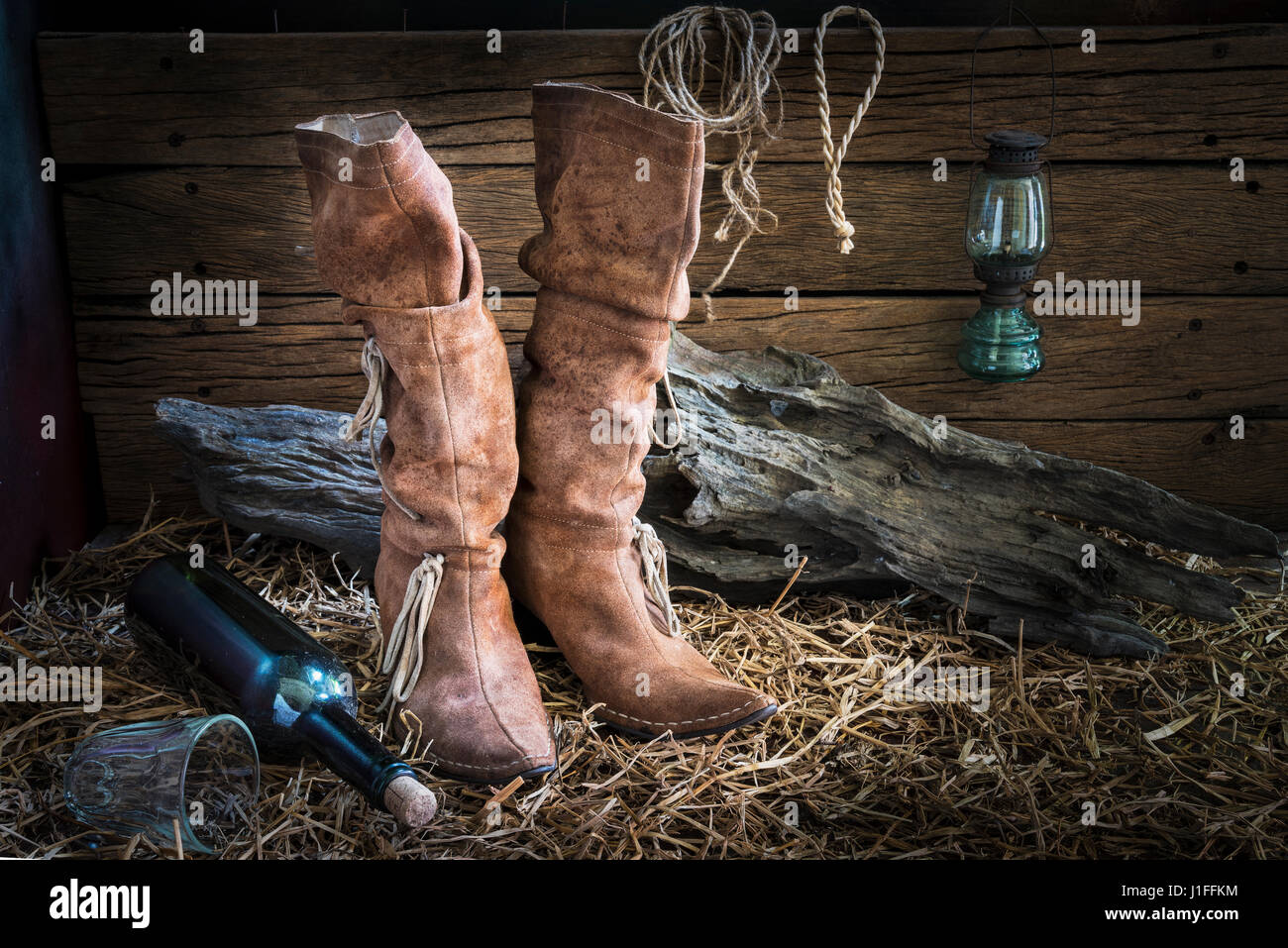 Still life photography with traditional leather boots in vintage ranch ...