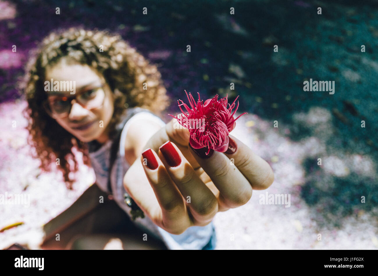 cute girl showing flower Stock Photo - Alamy