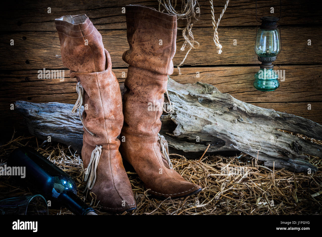 Still life photography with traditional leather boots in vintage ranch ...