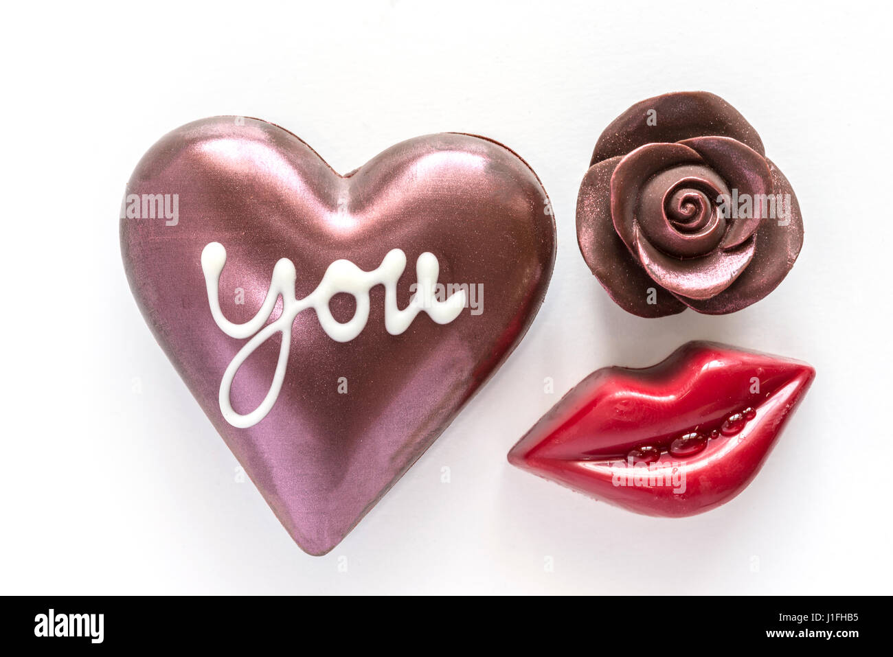 Chocolate heart with word you and chocolate rose with red mouth on ...