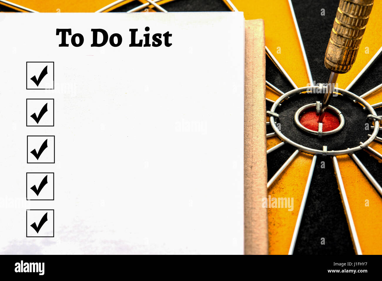 Personal notebook with a to do list and dart target arrow on the center ...