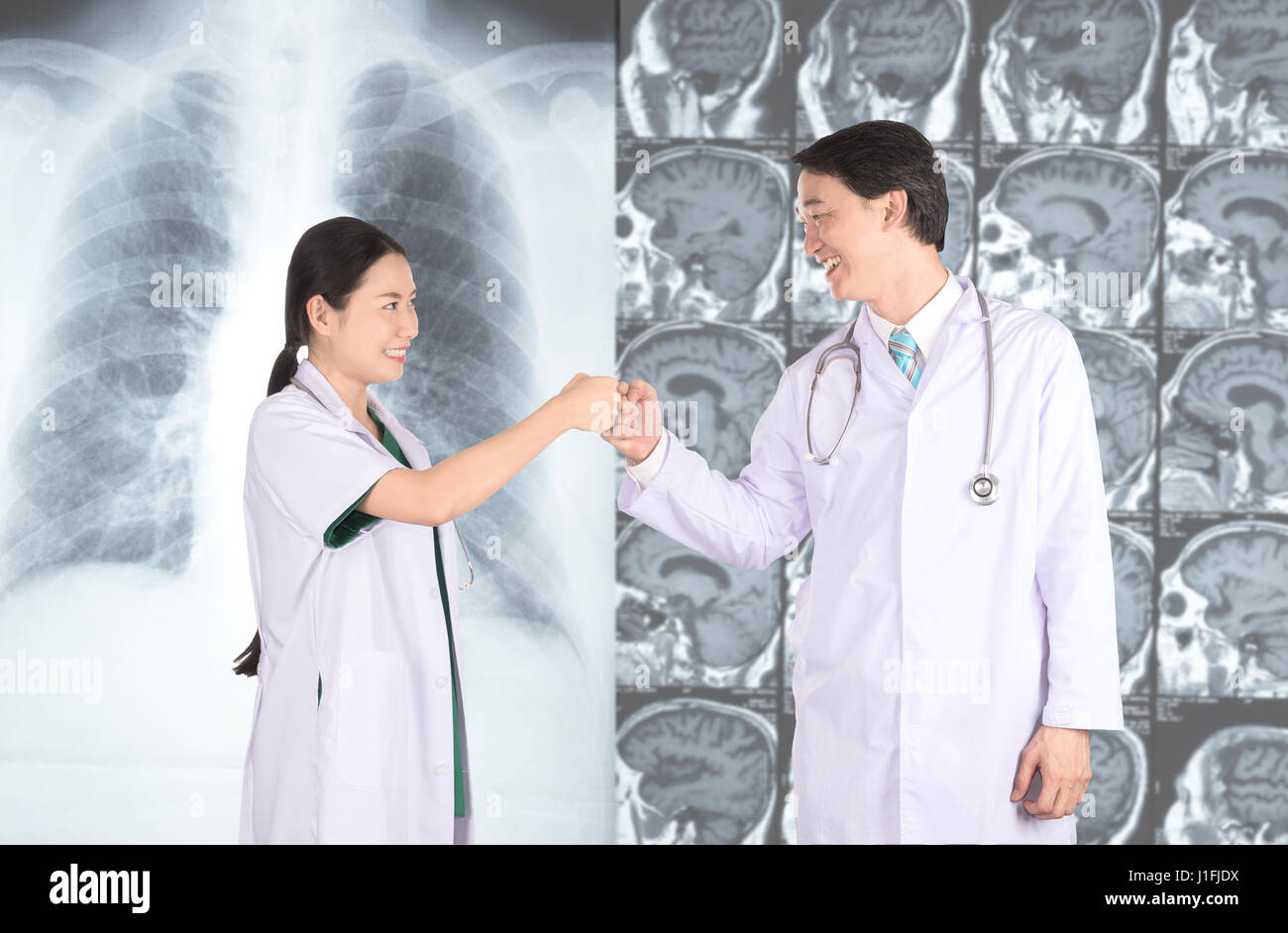 Portrait of two medical professional celebrating success over x ray ...