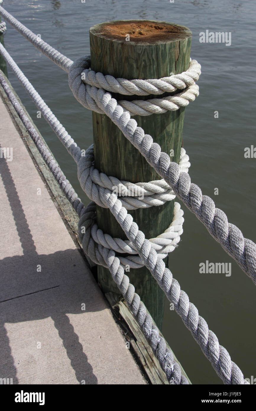 Fishing Pier Posts with Ropes on a Sunny Day Stock Photo - Alamy