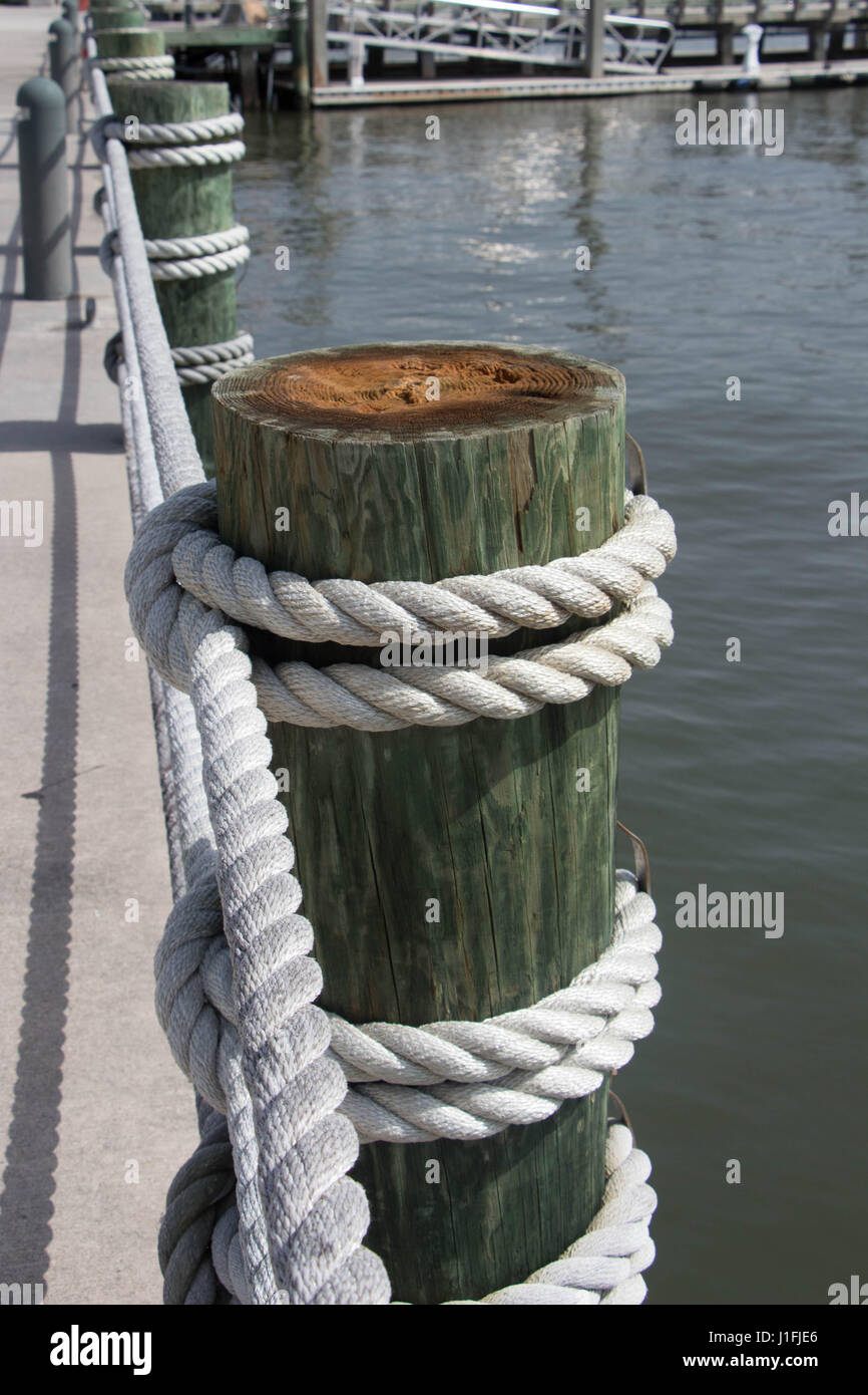 Fishing Pier Posts with Ropes on a Sunny Day Stock Photo - Alamy