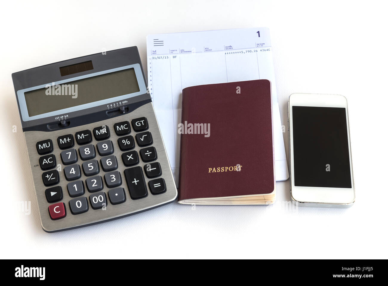 passport, calculator, mobile phone and saving account passbook on white ...
