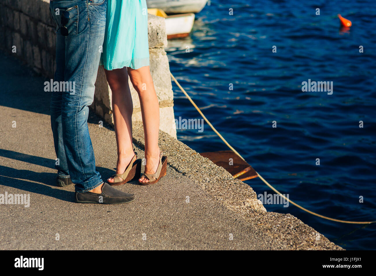 Female and male feet on the dock Stock Photo - Alamy