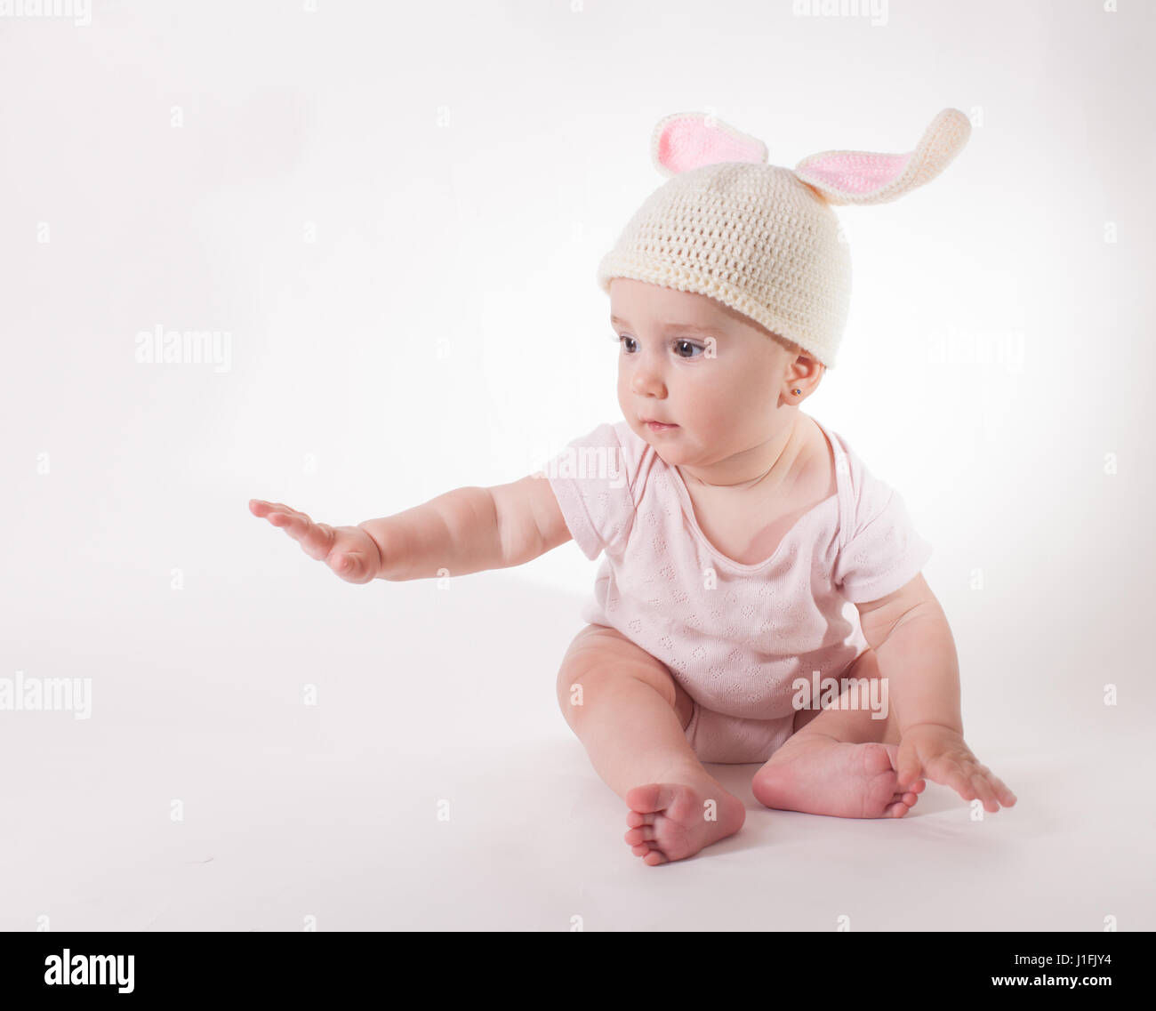 Baby girl in a rabbit hat Stock Photo - Alamy