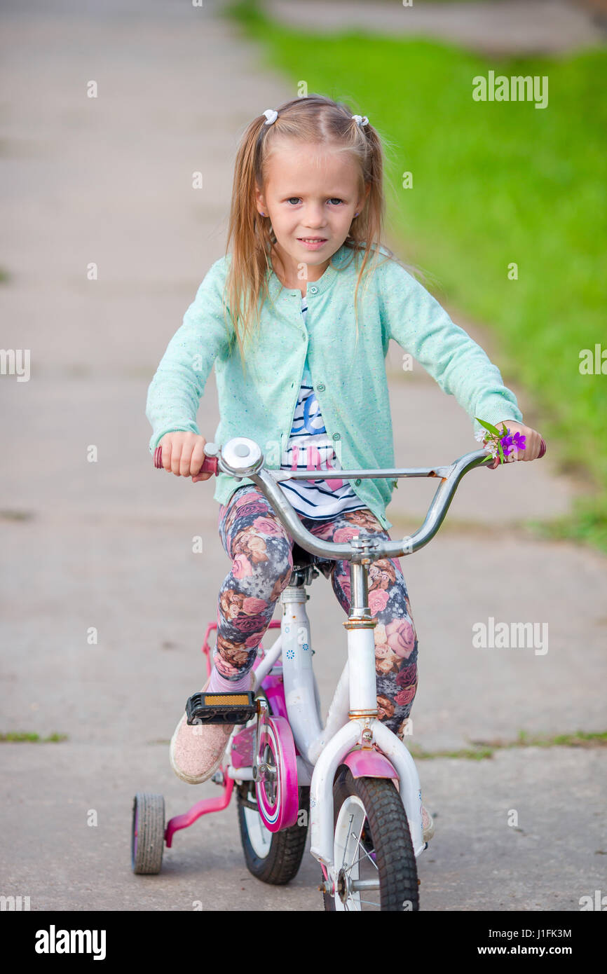 Adorable girl riding a bike on beautiful summer day Stock Photo - Alamy