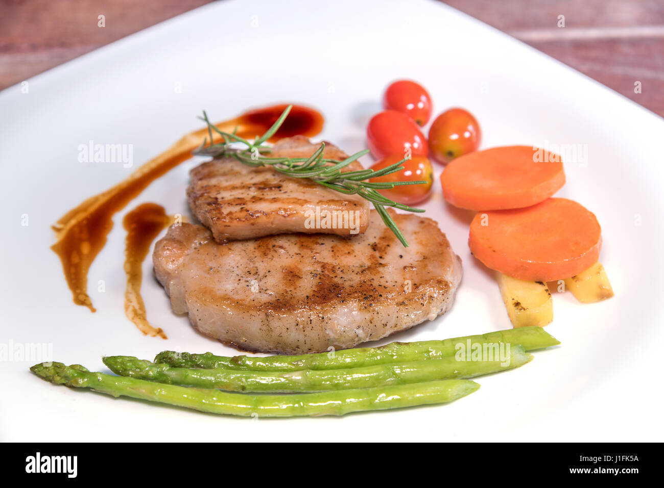 fried meat stake with vegetables in the plate Stock Photo - Alamy