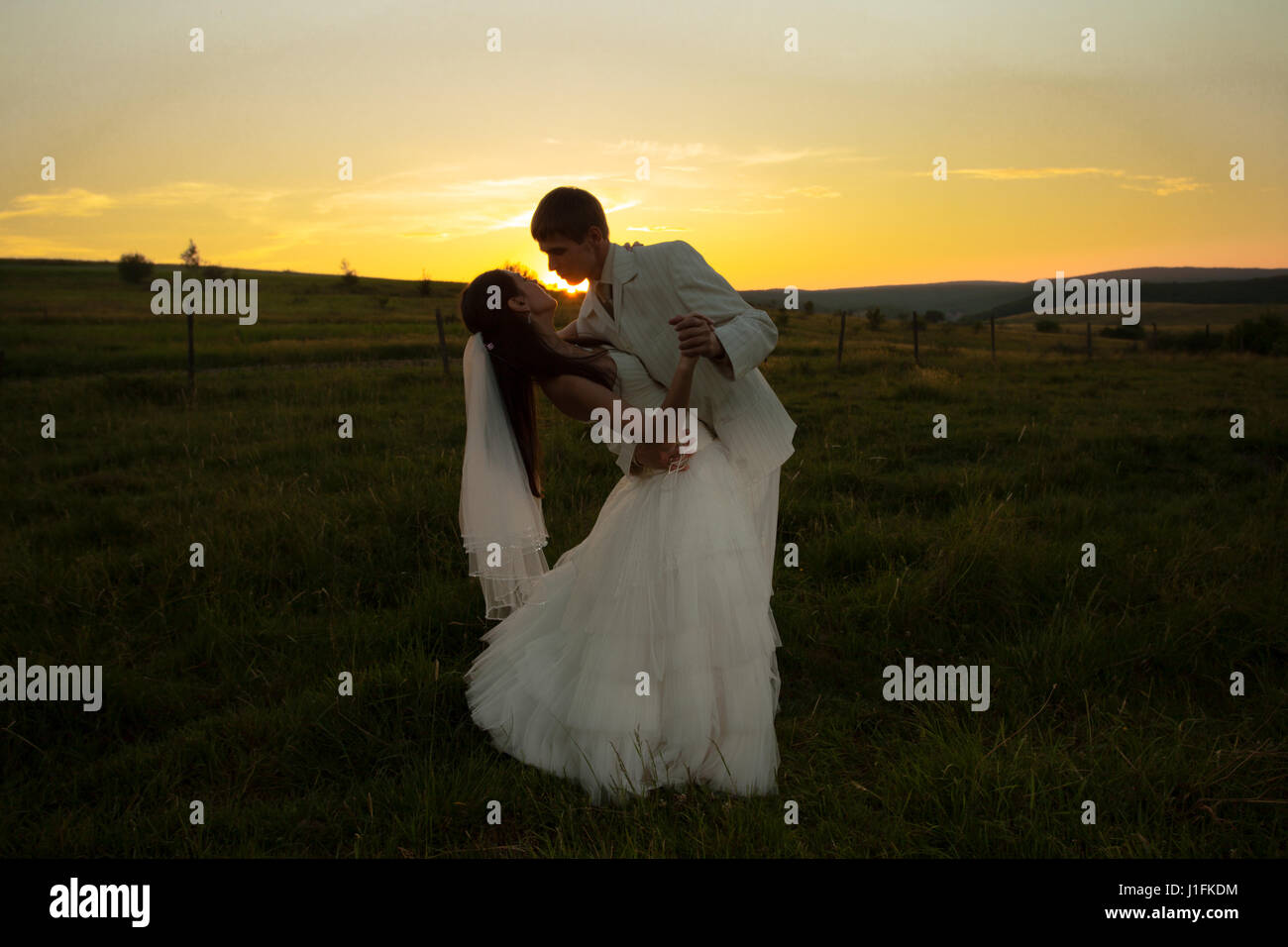 Wedding couple on sunset Stock Photo - Alamy