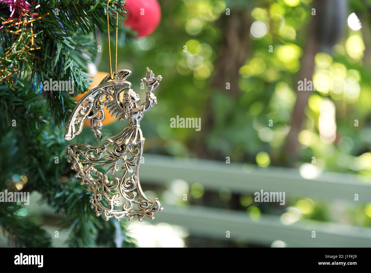 angel and a decorated christmas tree with streamer Stock Photo - Alamy