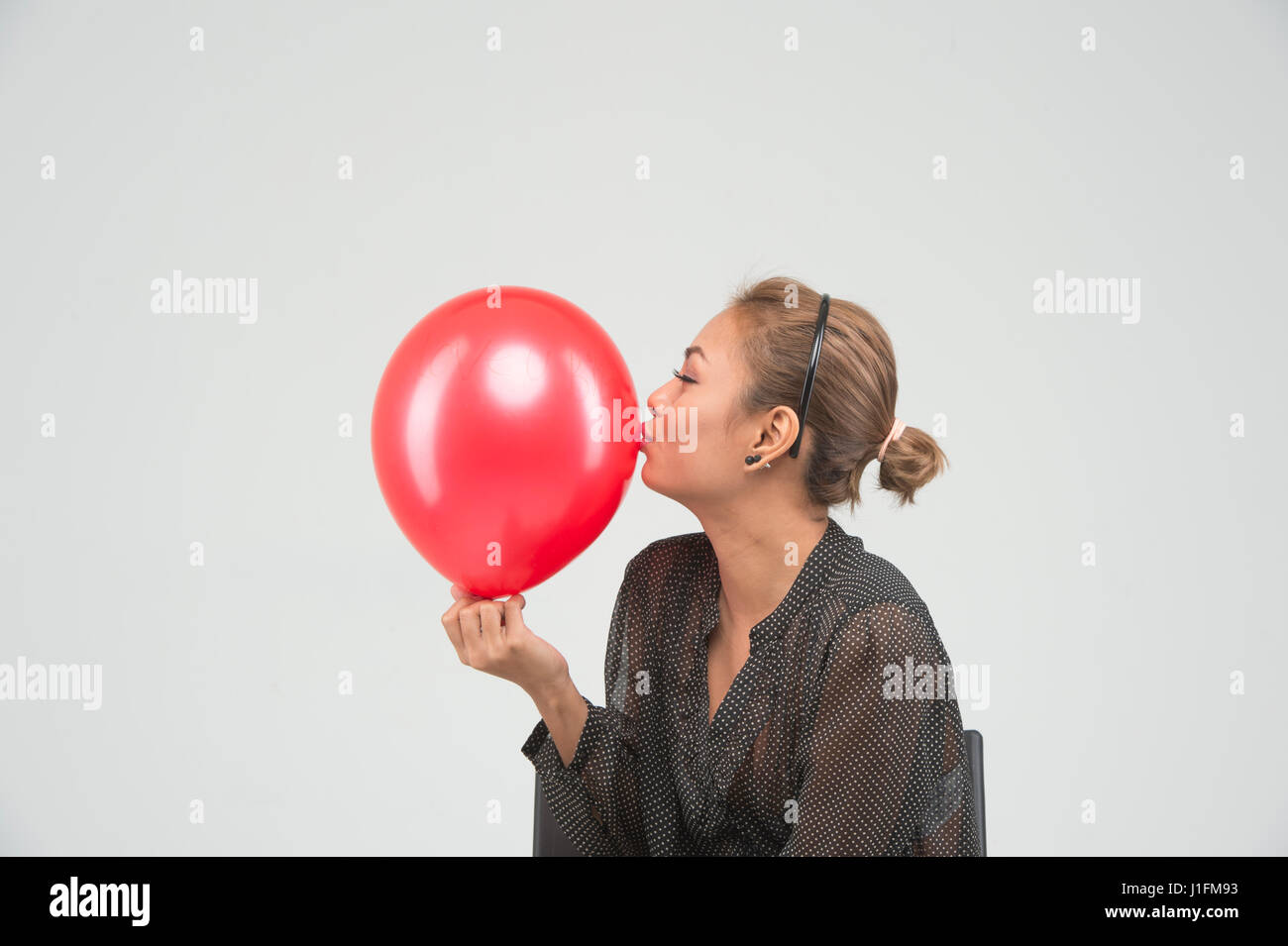 Happy beautiful asian girl play with the red balloon Stock Photo - Alamy