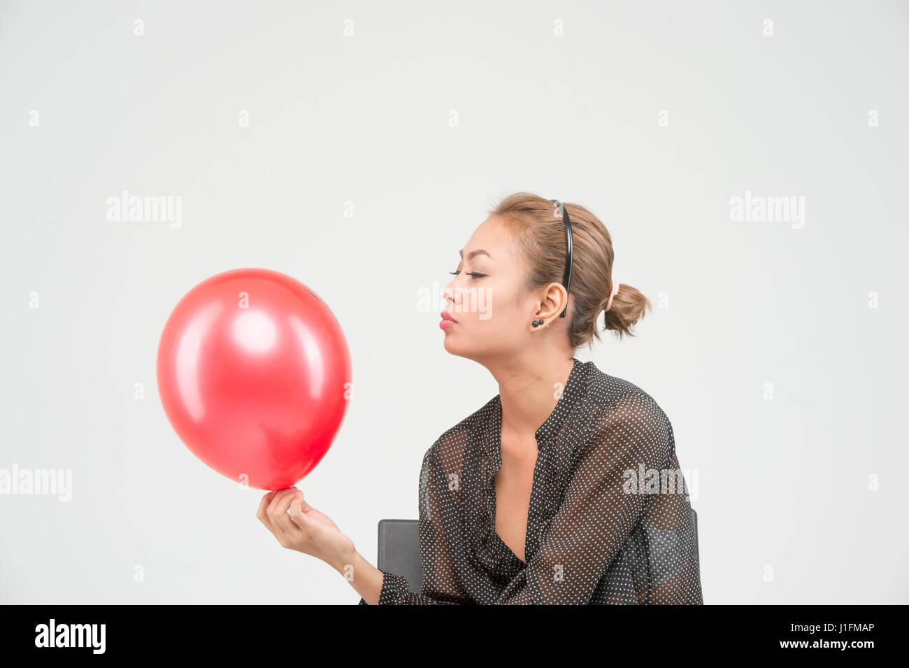 Happy beautiful asian girl play with the red balloon Stock Photo - Alamy