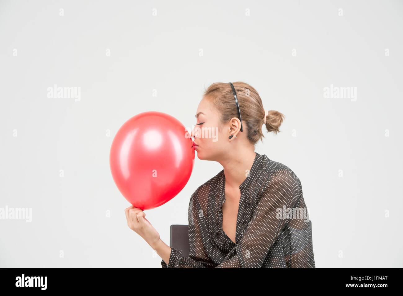 Happy beautiful asian girl play with the red balloon Stock Photo - Alamy