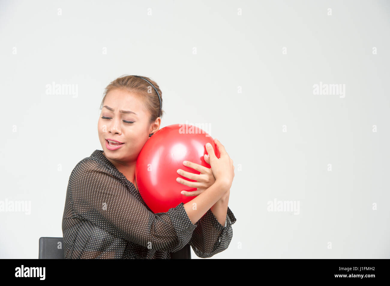 Happy beautiful asian girl play with the red balloon Stock Photo - Alamy