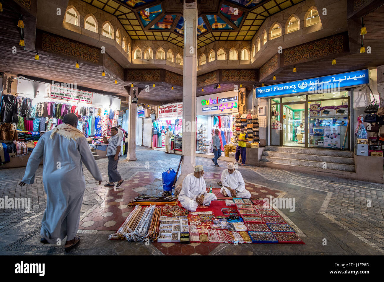 Muscat, Oman - Souq Muttrah Men sitting on carpet in market selling ...
