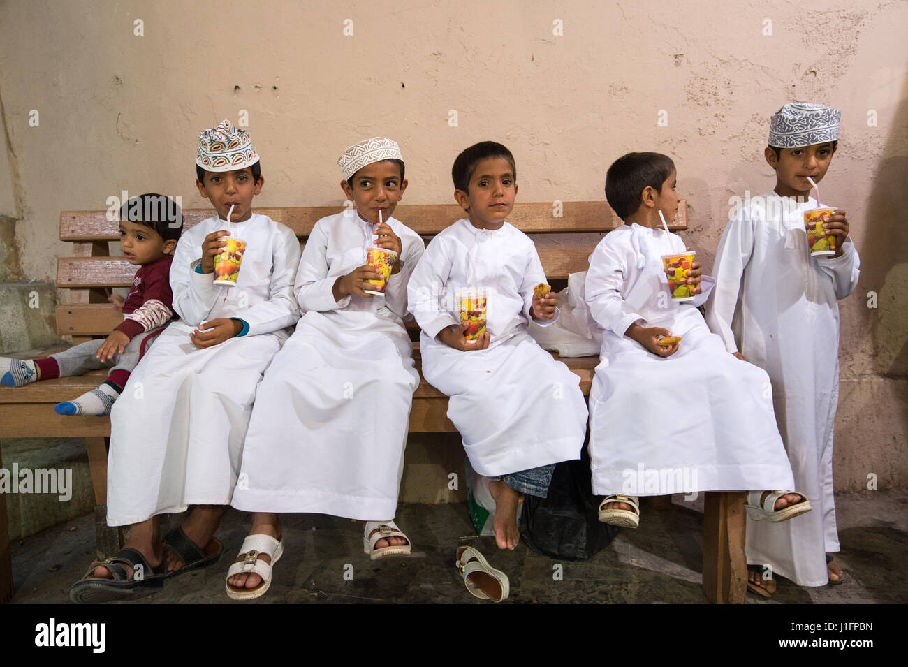 Muscat, Oman - Souq Muttrah Children drinking juice in market Stock ...