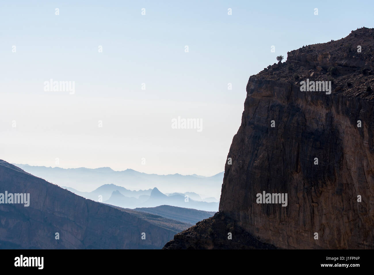 Oman; Rock formation at Al Hajar Mountains range silhouetted by skyline ...