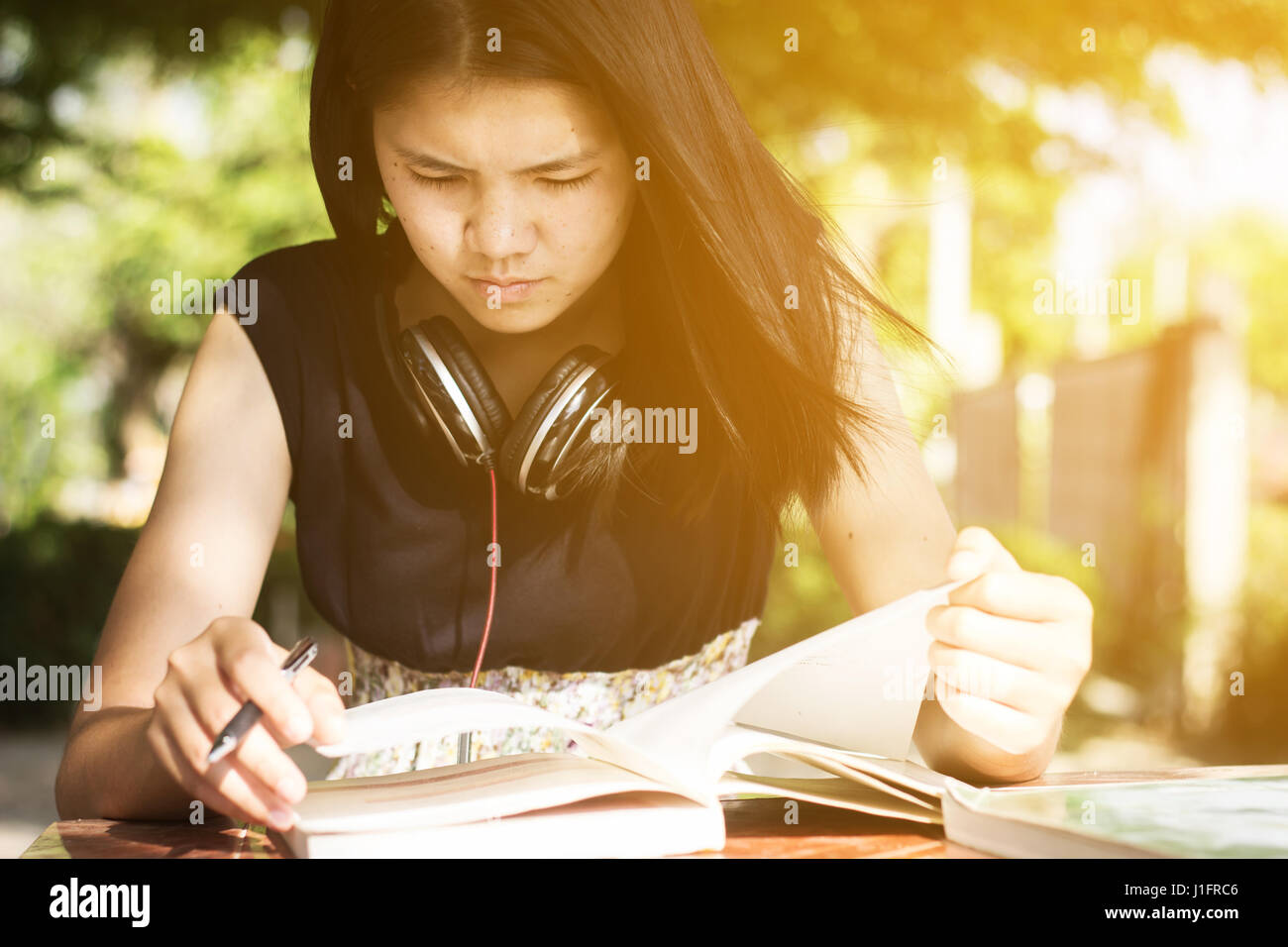 Asian teen student reading book preparing for exam Stock Photo - Alamy