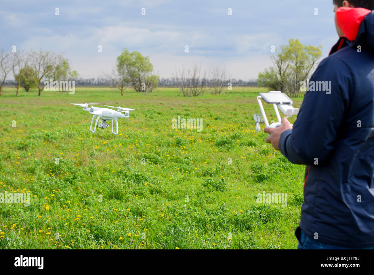 A man with a remote control in his hands. Flight control of the drone ...
