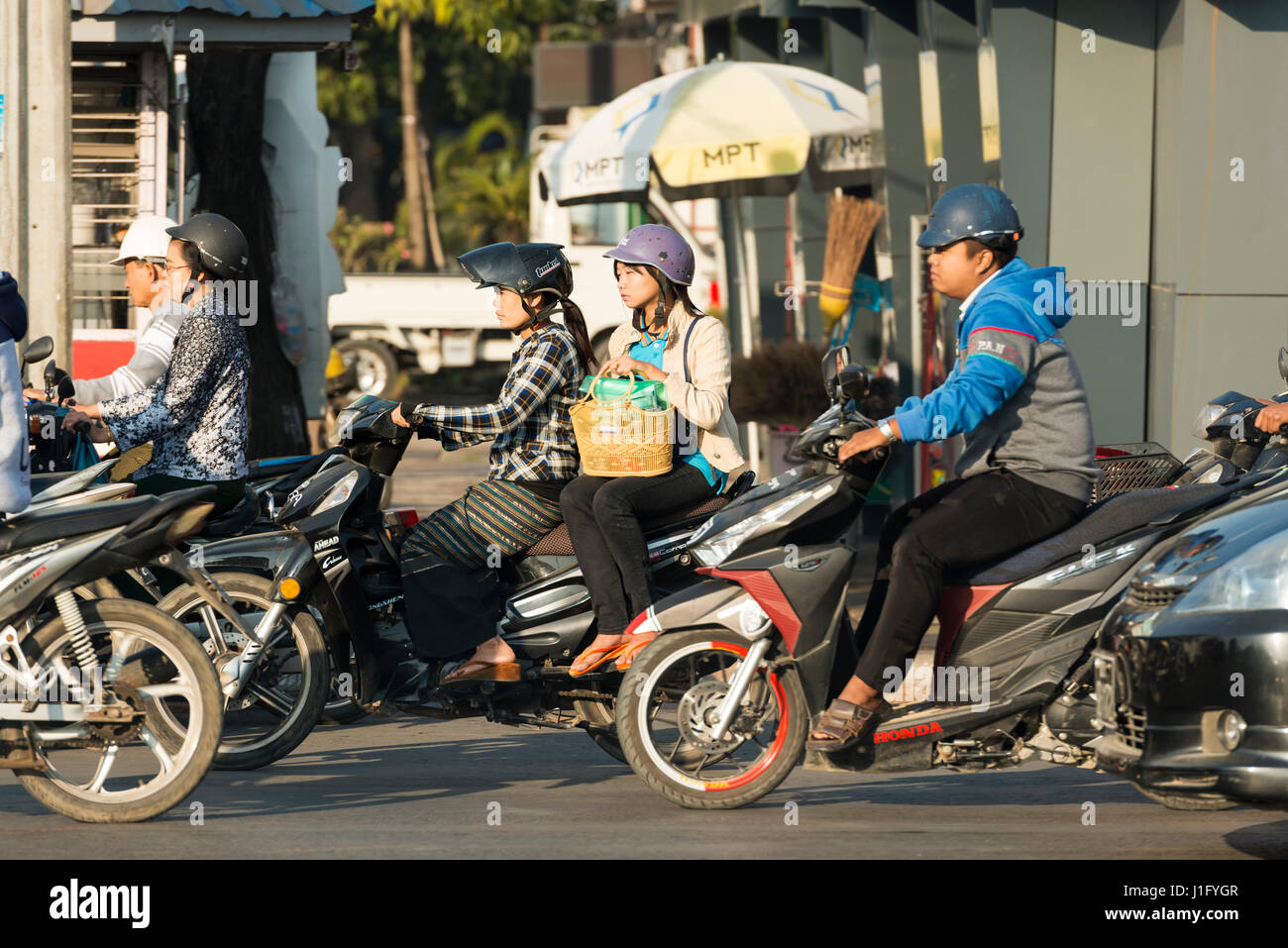 Motorcycle commuters on 80th Street, Mandalay, Myanmar Stock Photo - Alamy