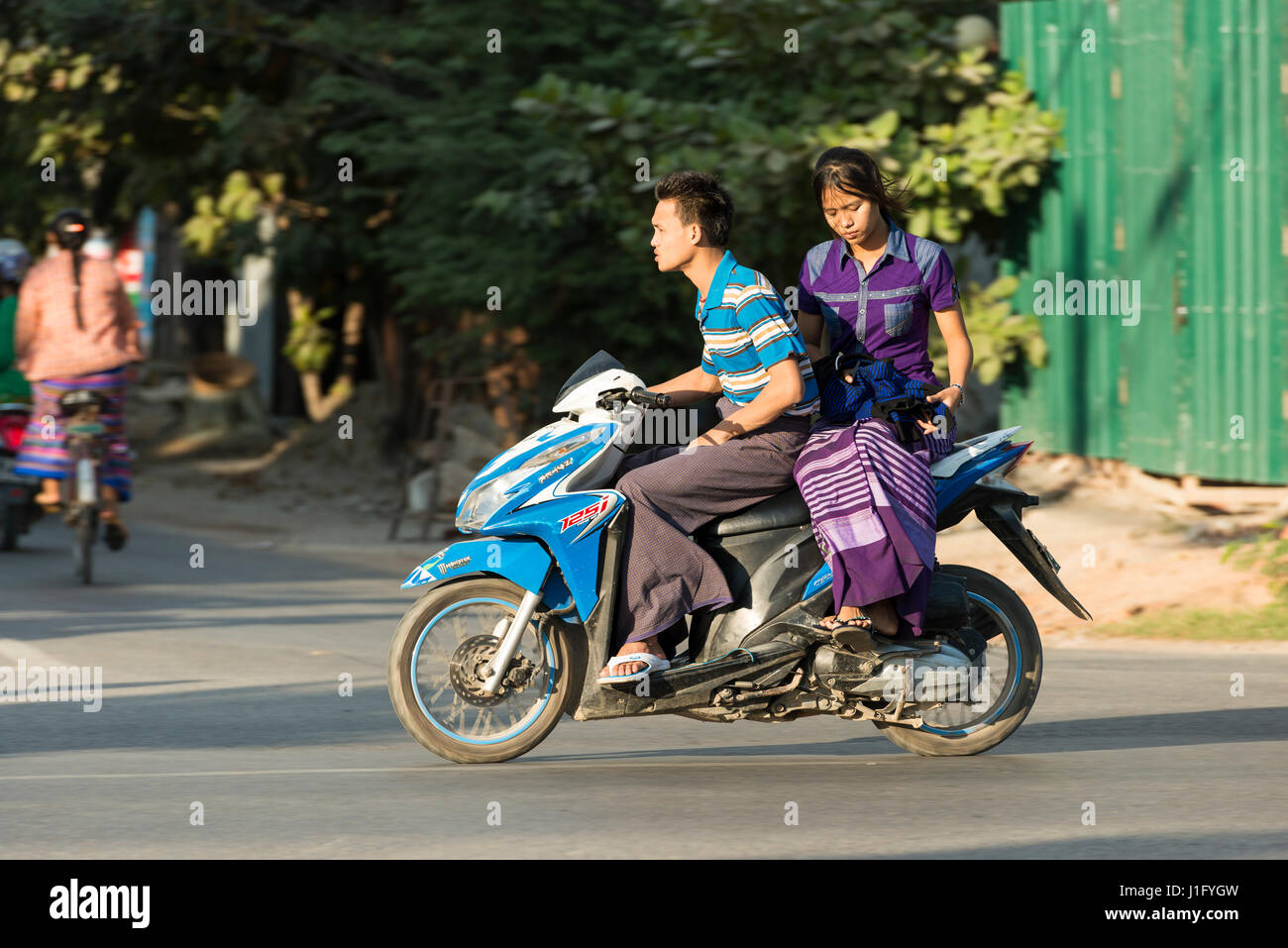Motorcycle commuters on 80th Street, Mandalay, Myanmar Stock Photo - Alamy